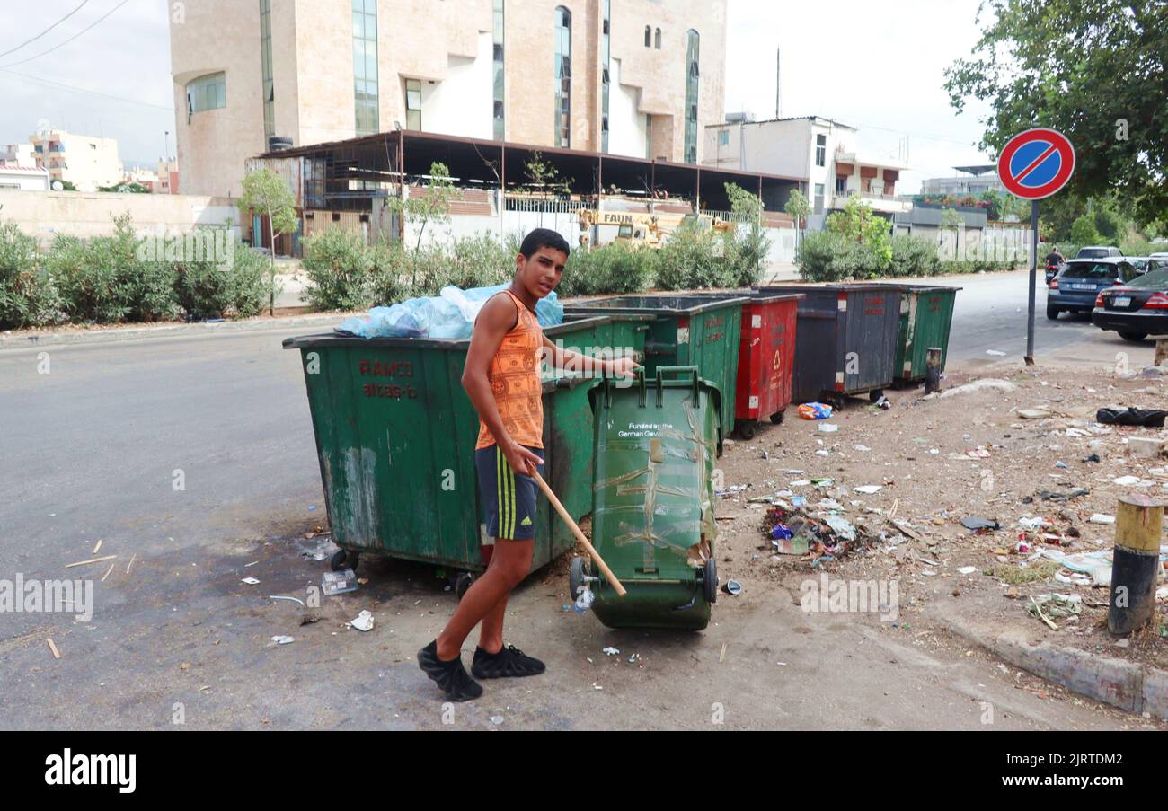 A boy collects garbage in a street of Beirut, Lebanon, on August 24 ...