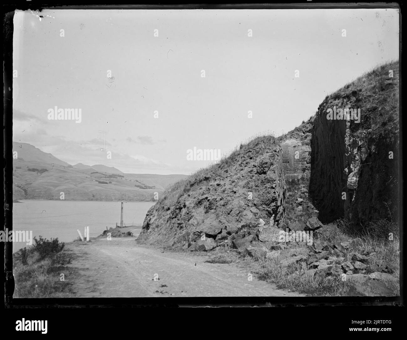 Untitled (road running past hillside), New Zealand, by Leslie Adkin ...