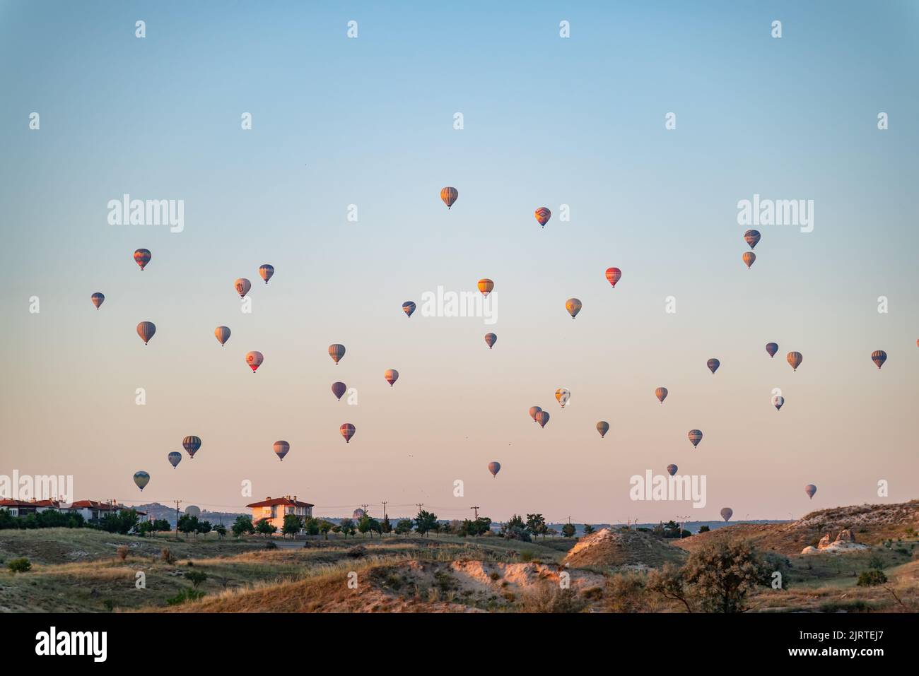 Floating air balloons on the sunrise above the valley in Goreme, view ...