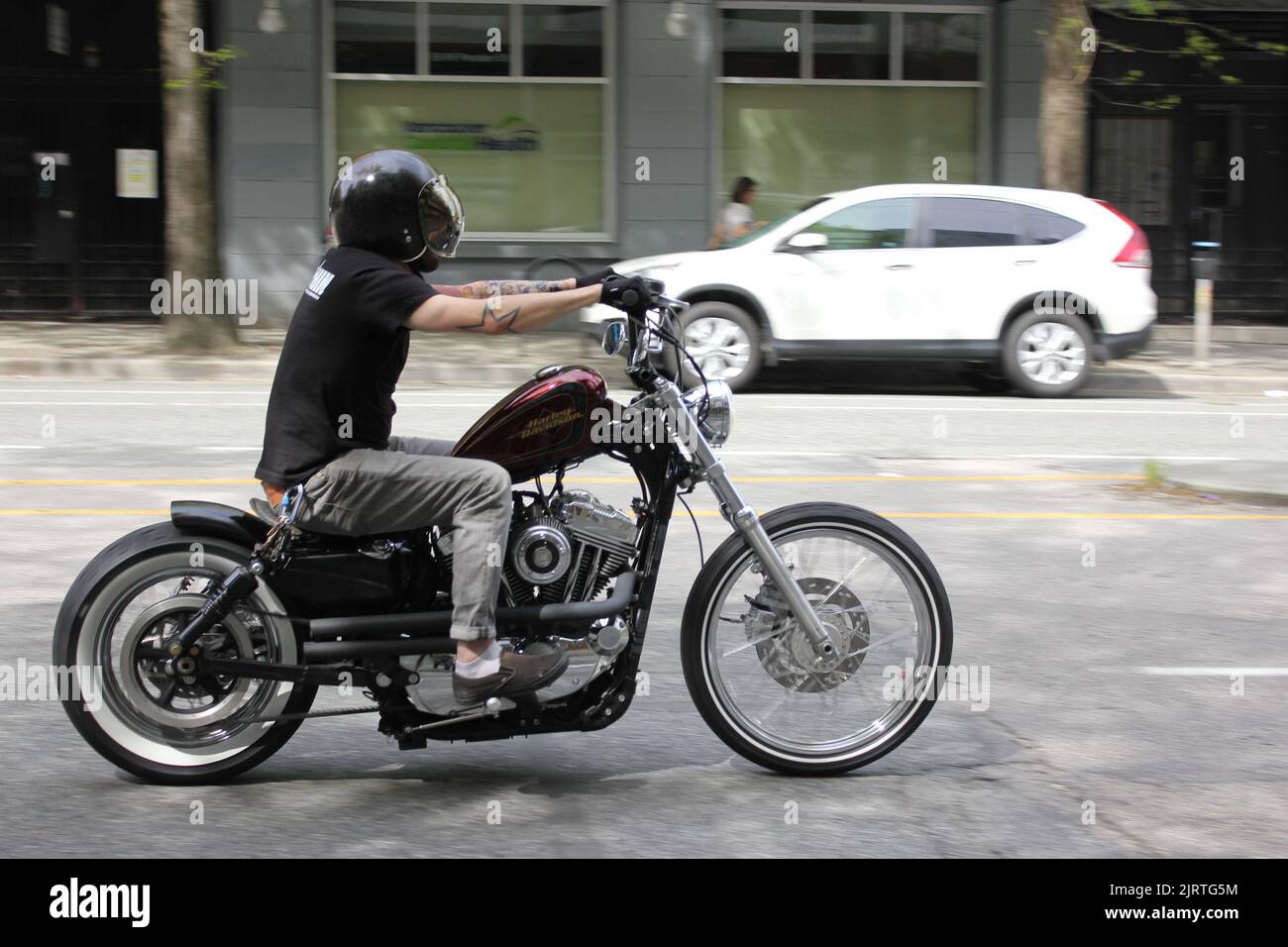 A person riding a motorcycle in downtown Vancouver, British Columbia ...