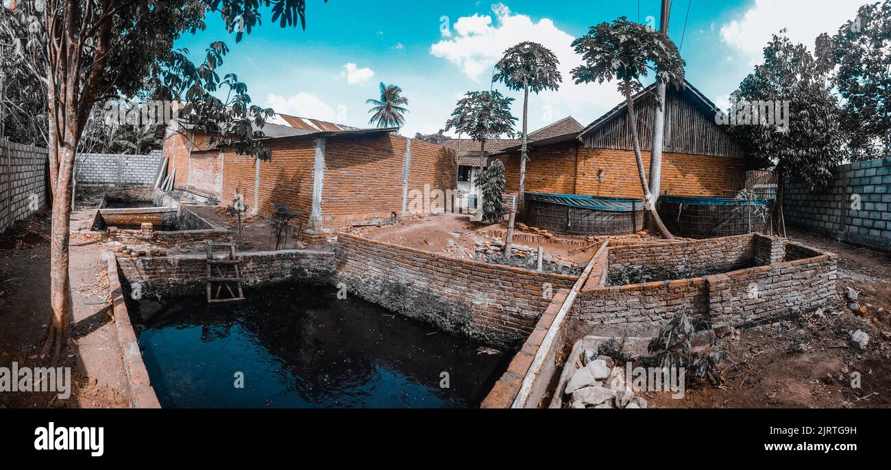 An old wooden cabin with an empty pool Stock Photo - Alamy