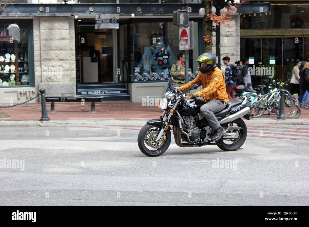 A person riding a motorcycle in downtown Vancouver, British Columbia ...