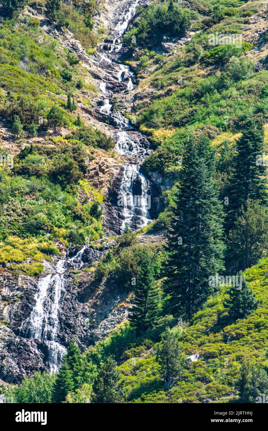 A drone shot of beautiful long waterfall flowing down from the ...