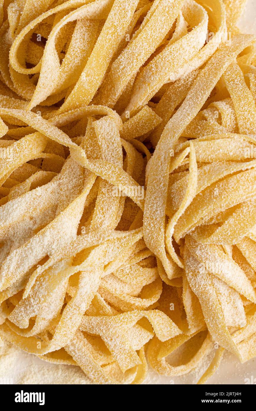 A vertical closeup shot of dry pasta covered with flour Stock Photo - Alamy