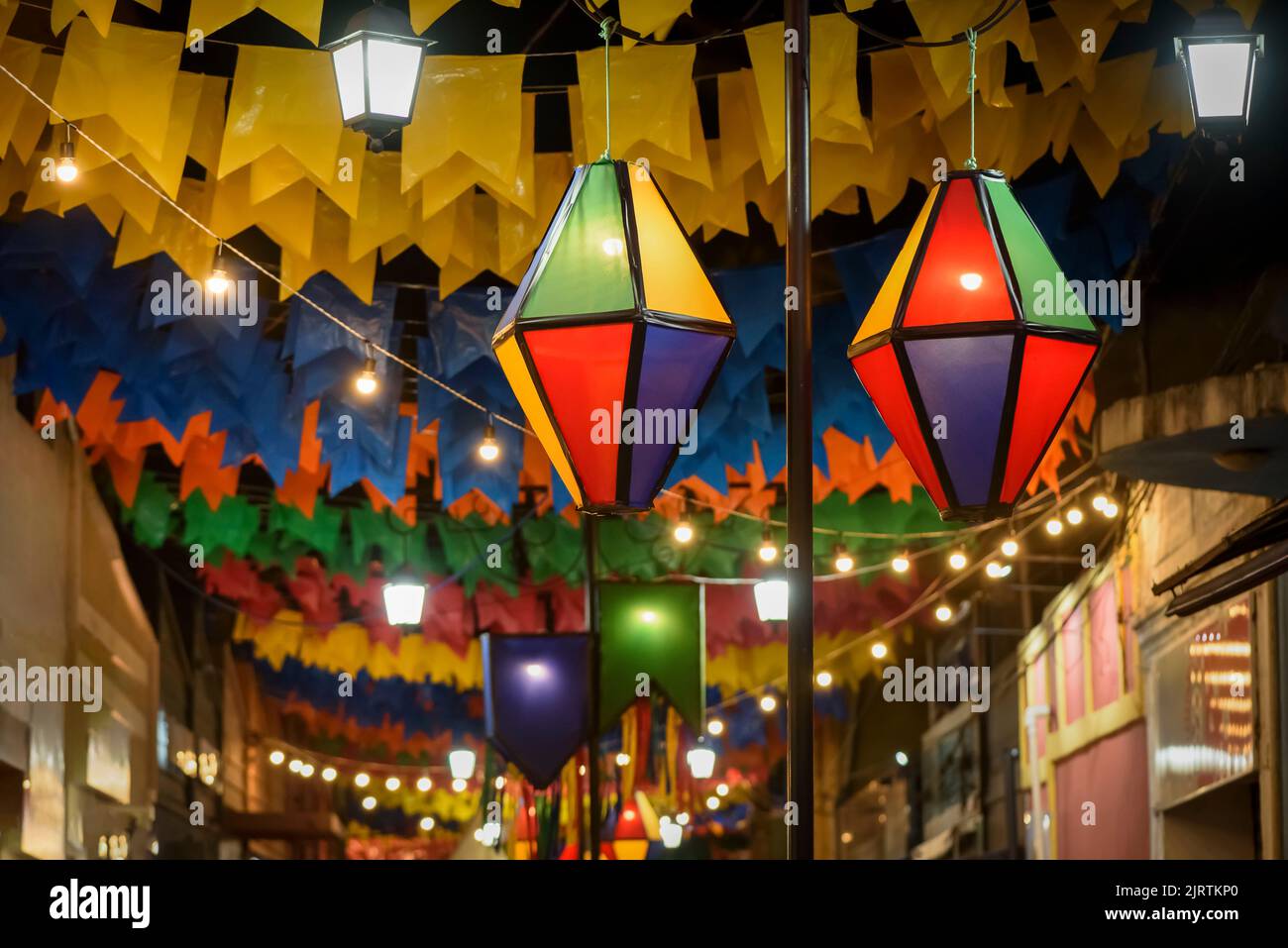 Decorative balloons and colorful flags on the street for the São João ...