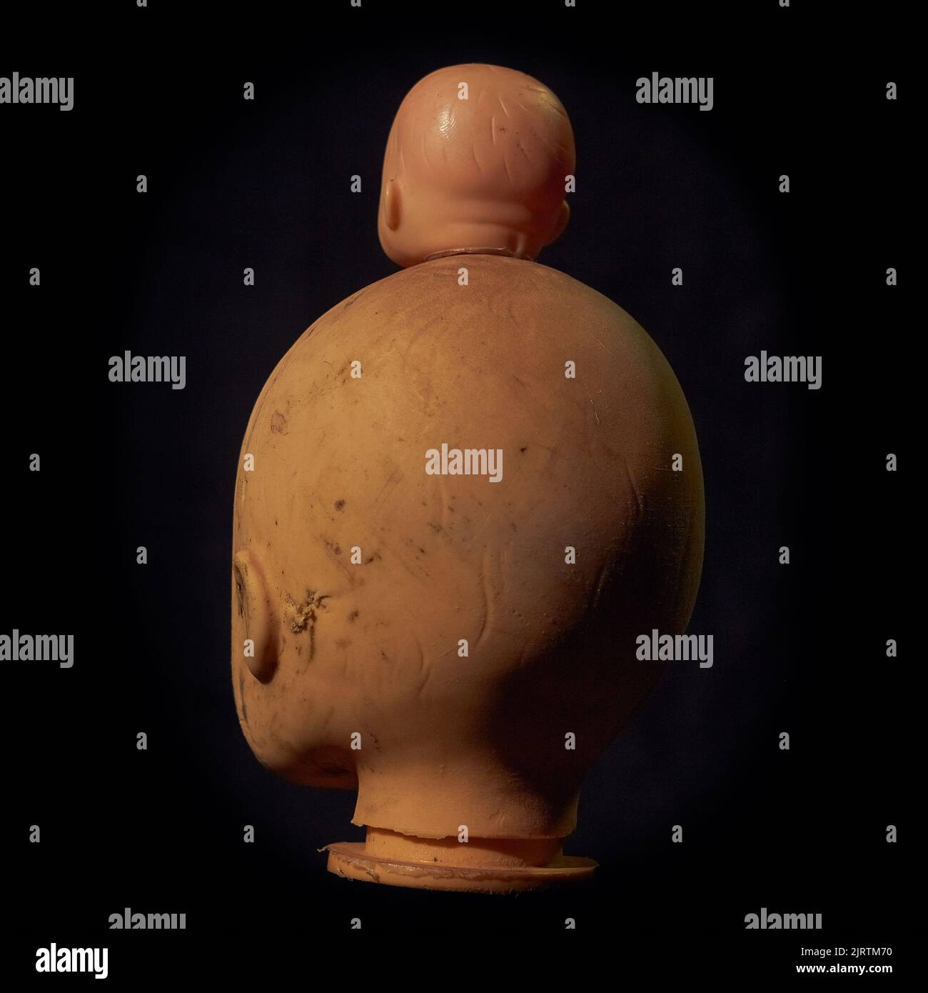 Damaged Dirty Doll head on black background isolated Stock Photo - Alamy