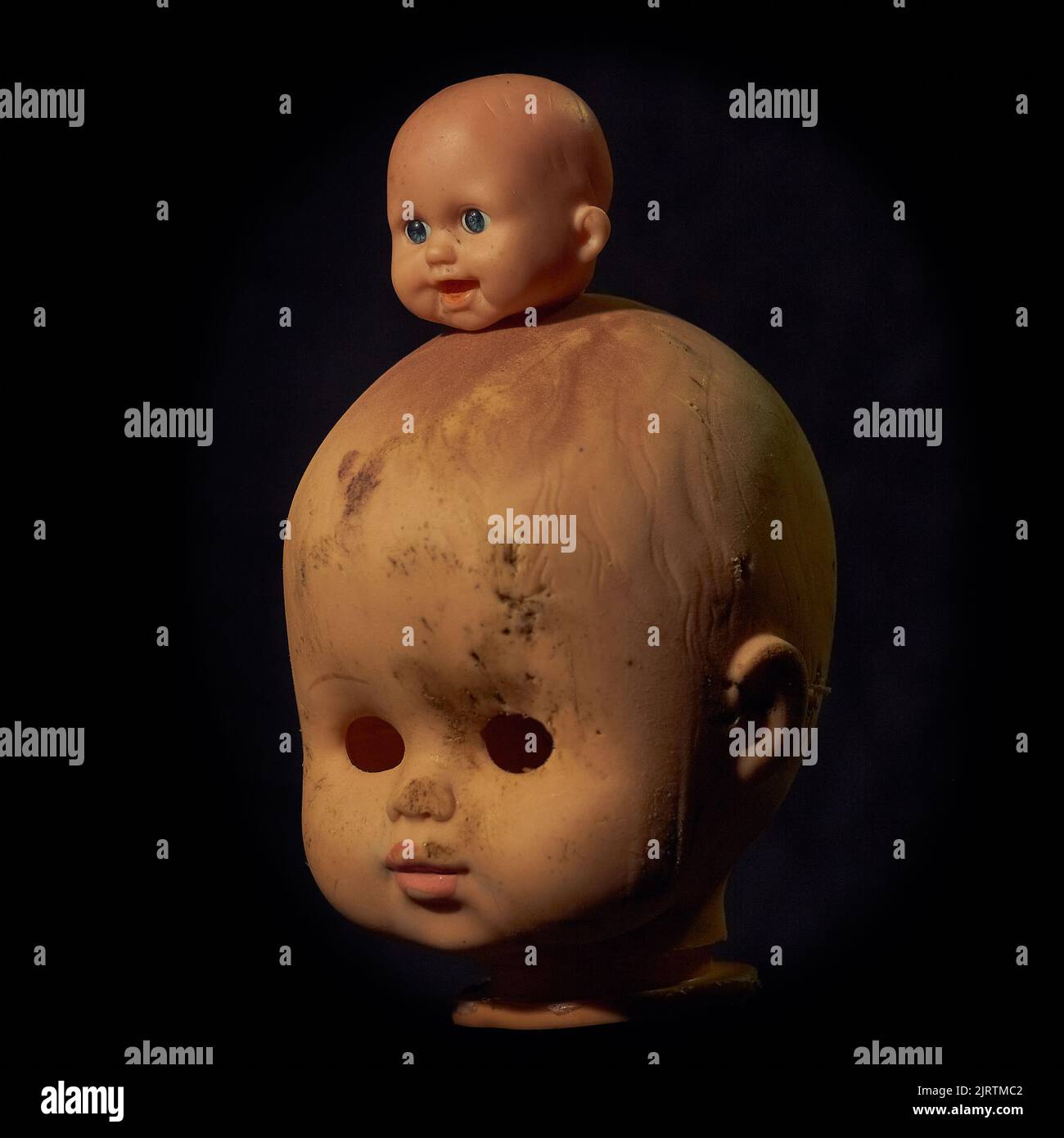 Damaged Dirty Doll head on black background isolated Stock Photo - Alamy