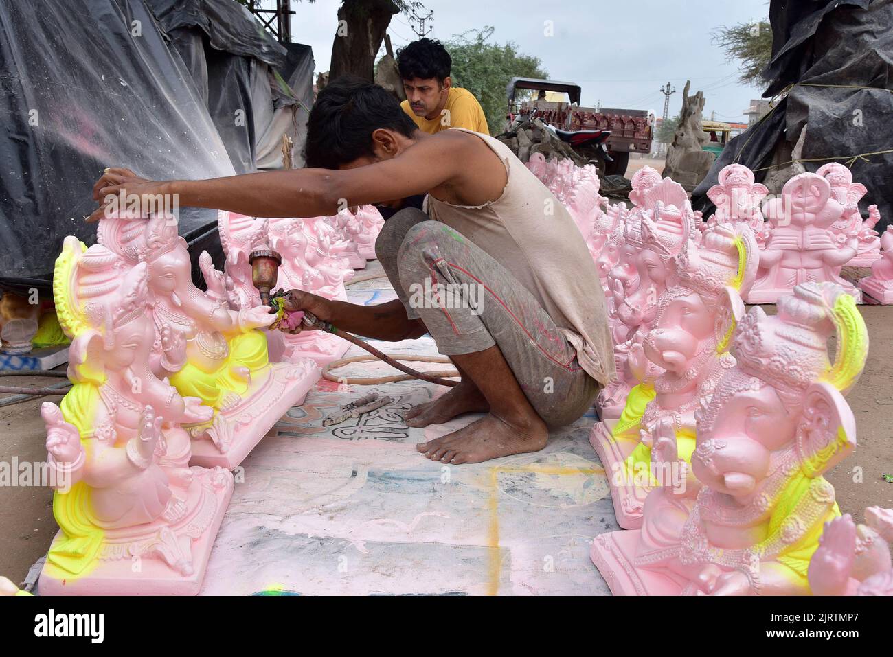Bikaner, India. 25th Aug, 2022. An artist is seen working on the idol ...
