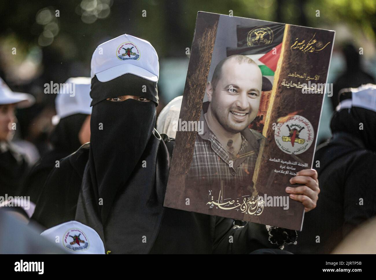 A woman holds a picture of a Palestinian prisoner during an anti-Israel ...