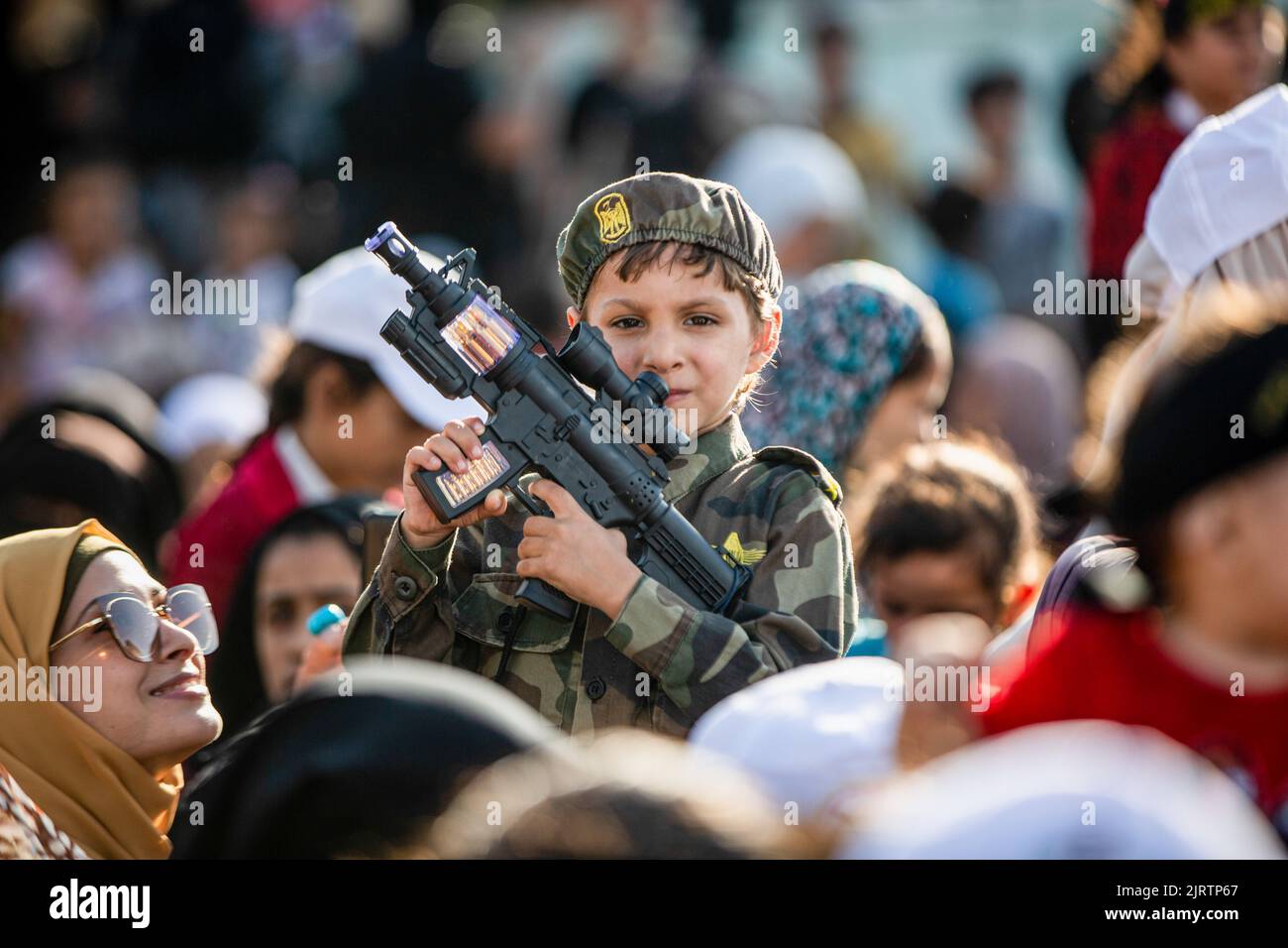 A Palestinian child carries a toy gun during an anti-Israel Islamic ...