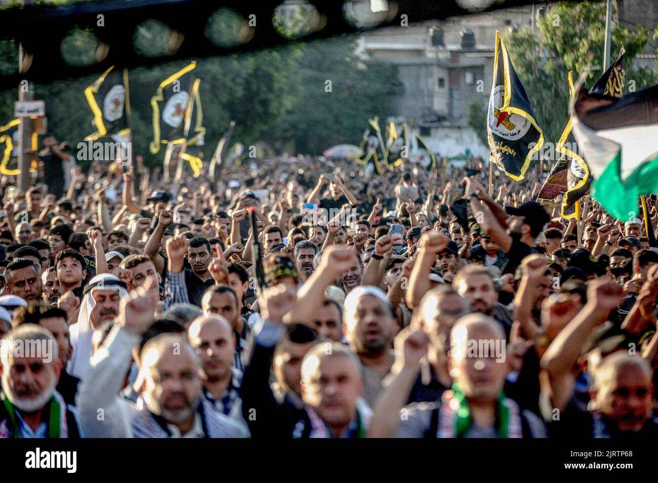 Islamic Jihad supporters wave their flags while chanting slogans during ...