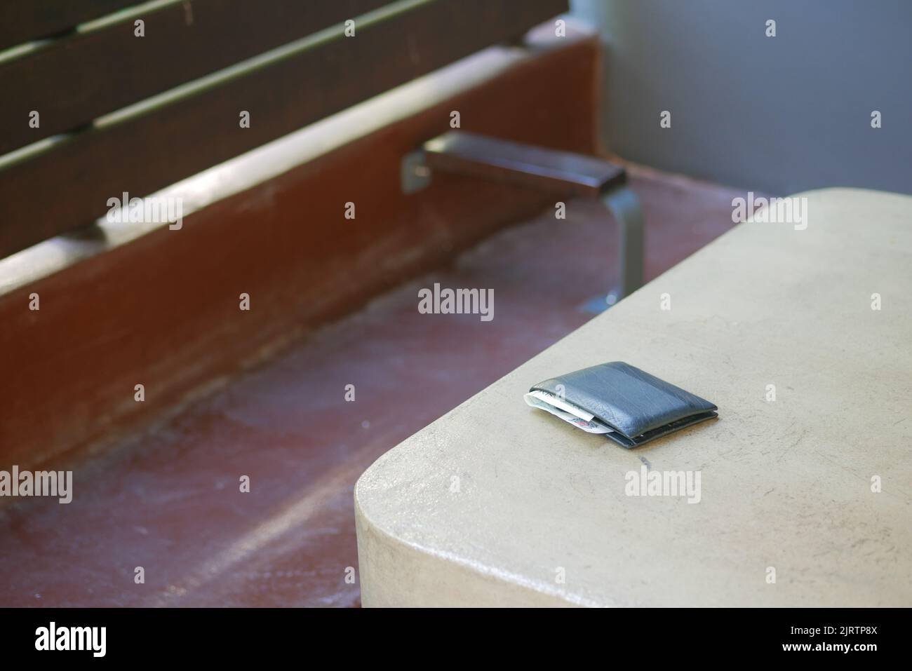 left wallet on a bench in the park Stock Photo - Alamy