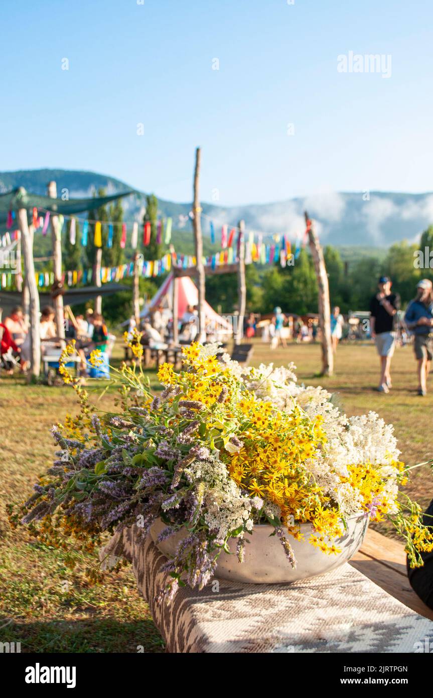 Beautiful bouquet of wild flowers on the summer festival on the field ...