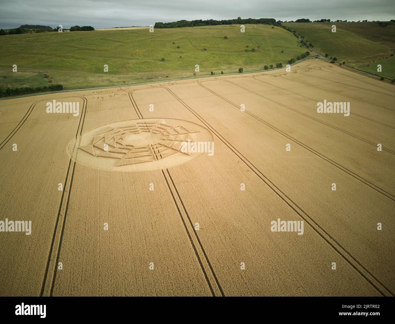 An aerial view of crop circles in a vast agricultural field in the countryside of Wiltshire ...