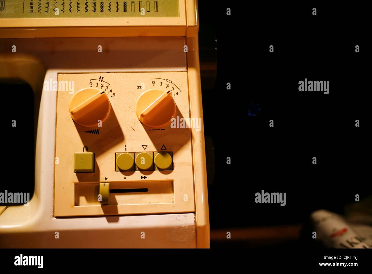 Sewing machine on table in tailor's workshop Stock Photo - Alamy