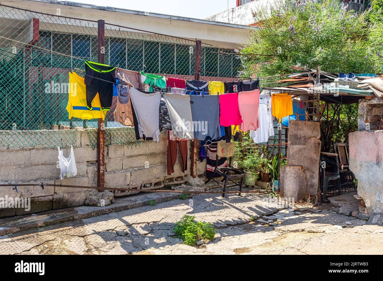 A clothesline full of textile articles drying in the wind and sunlight ...