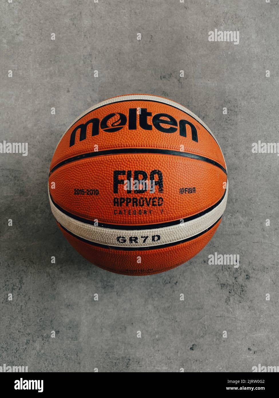 A vertical closeup of a basketball on a gray surface Stock Photo - Alamy