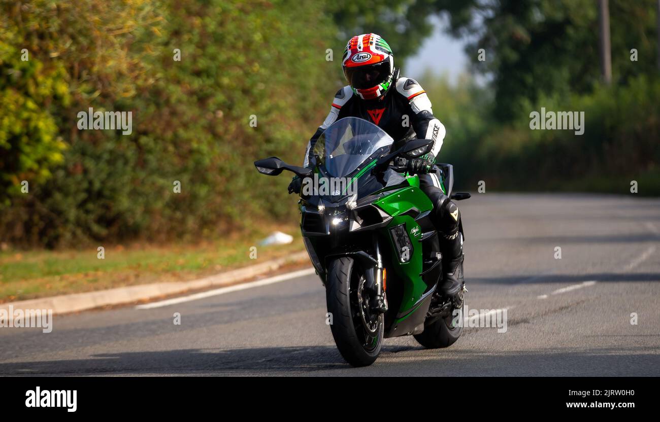 Man in black and white leather riding a Kawasaki Ninja motorcycle Stock ...