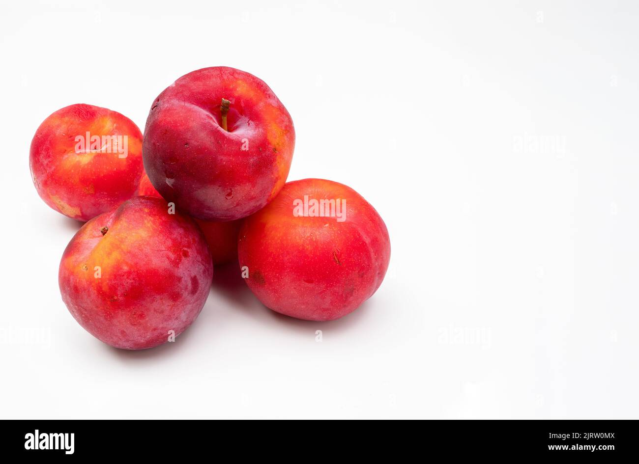 Freshly harvested sweet juicy plums on a white background Stock Photo ...