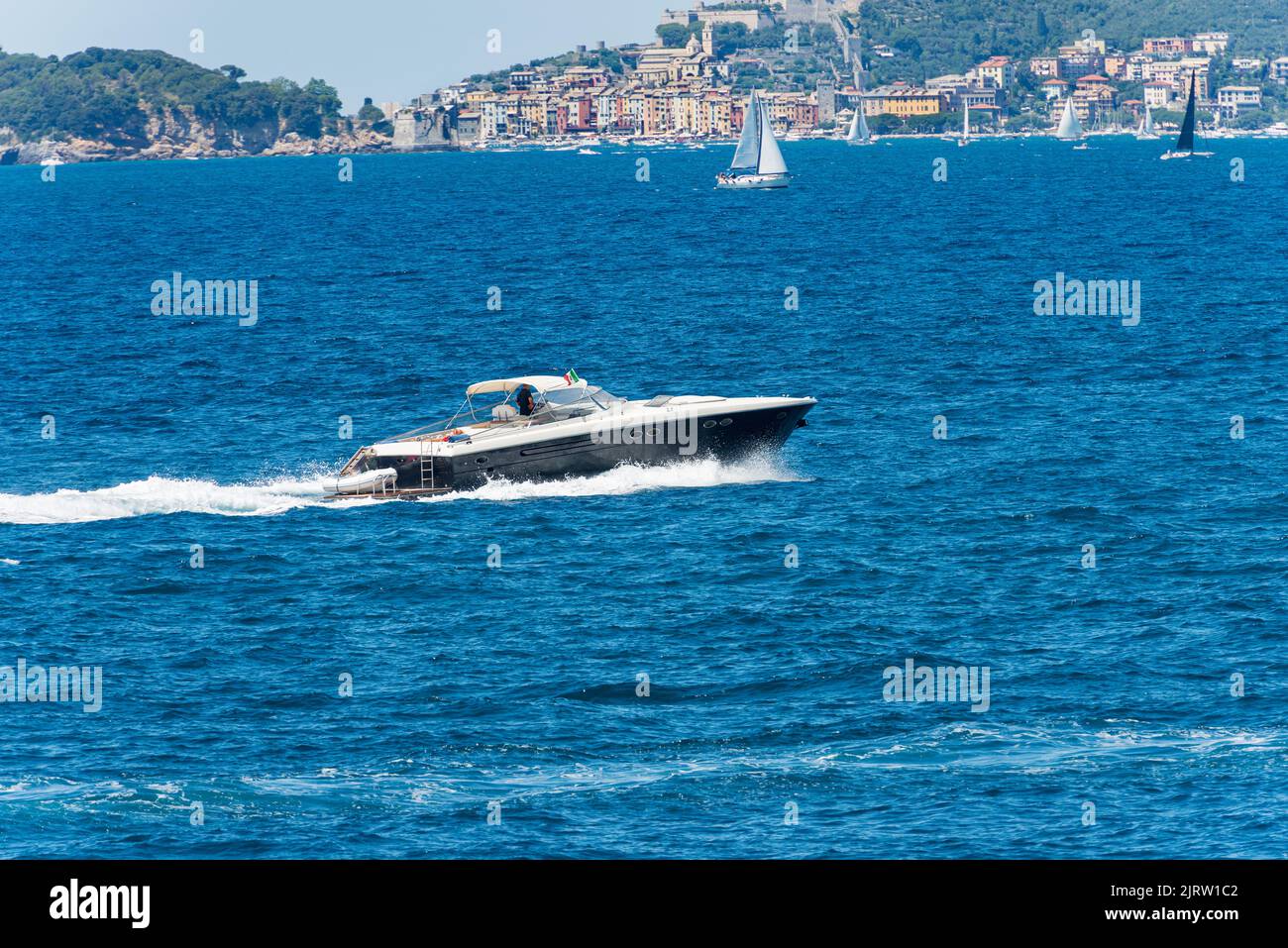 Luxury speedboat or yacht in motion on Mediterranean sea in front of ...