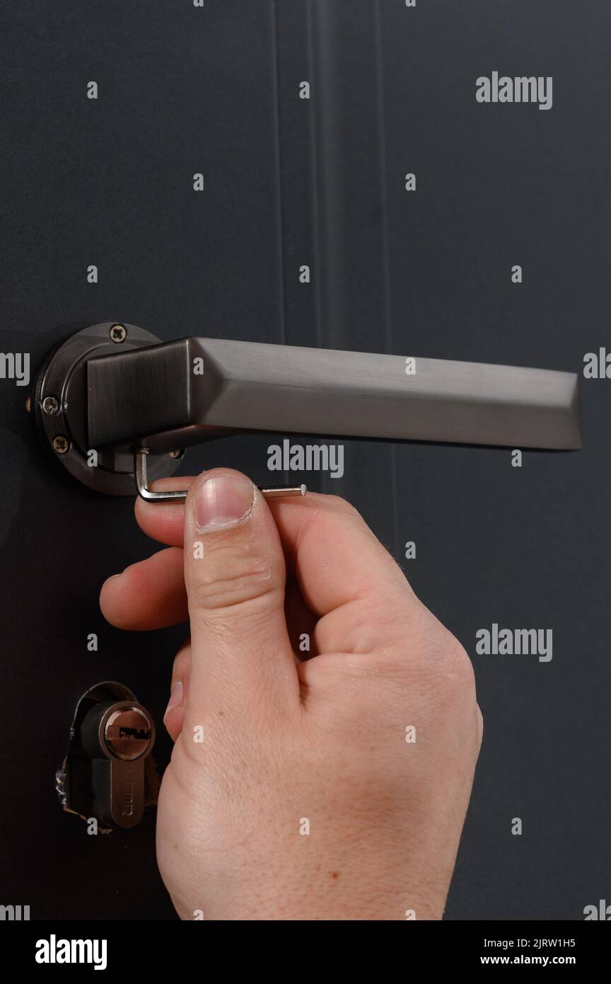 Hex key and installation of door lock and handle, close-up installation ...