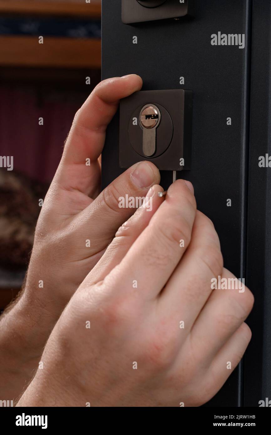 Hex key and installation of door lock and handle, close-up installation ...