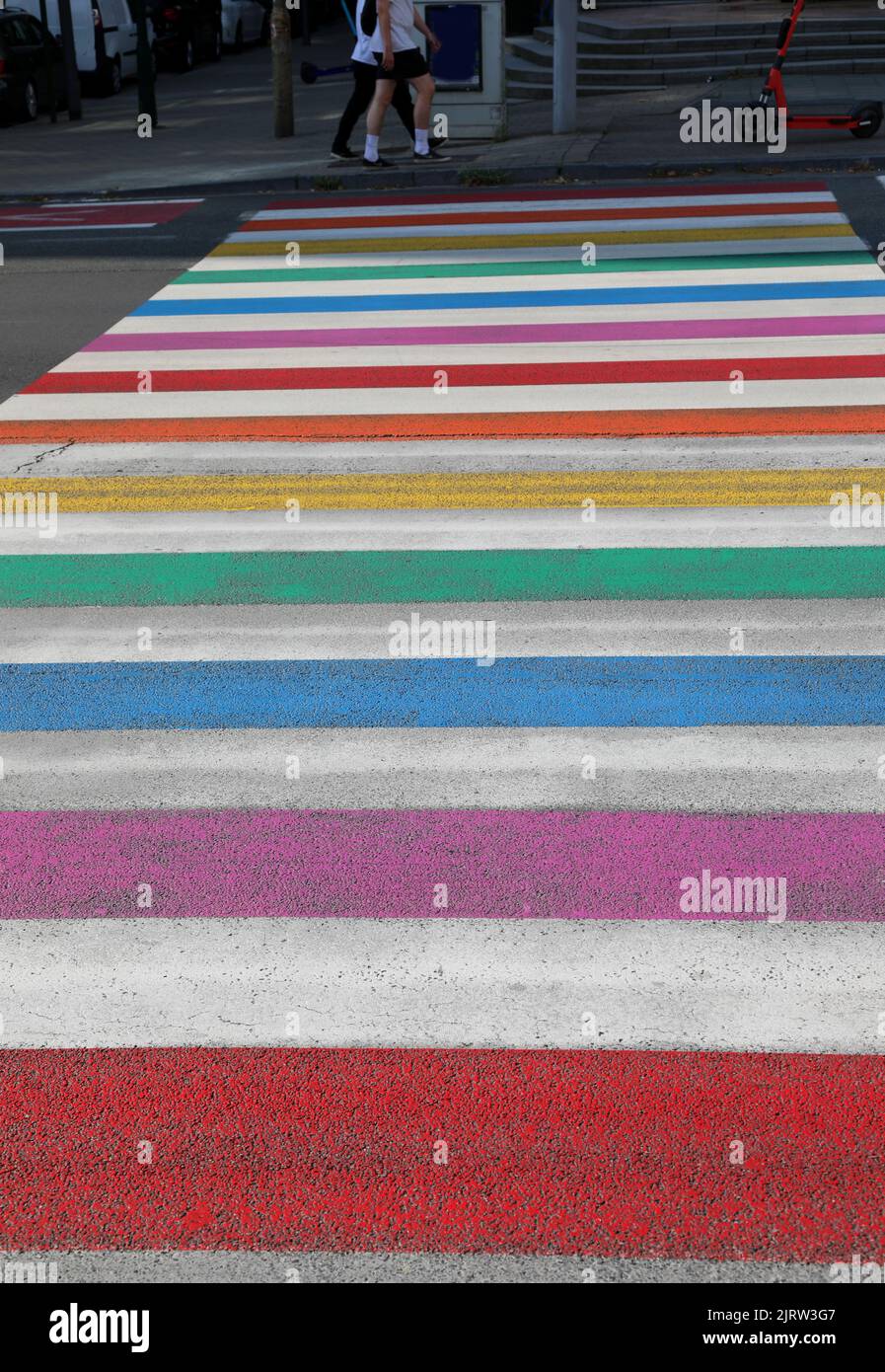 large pedestrian crossing with lines of many rainbow colors in the city ...