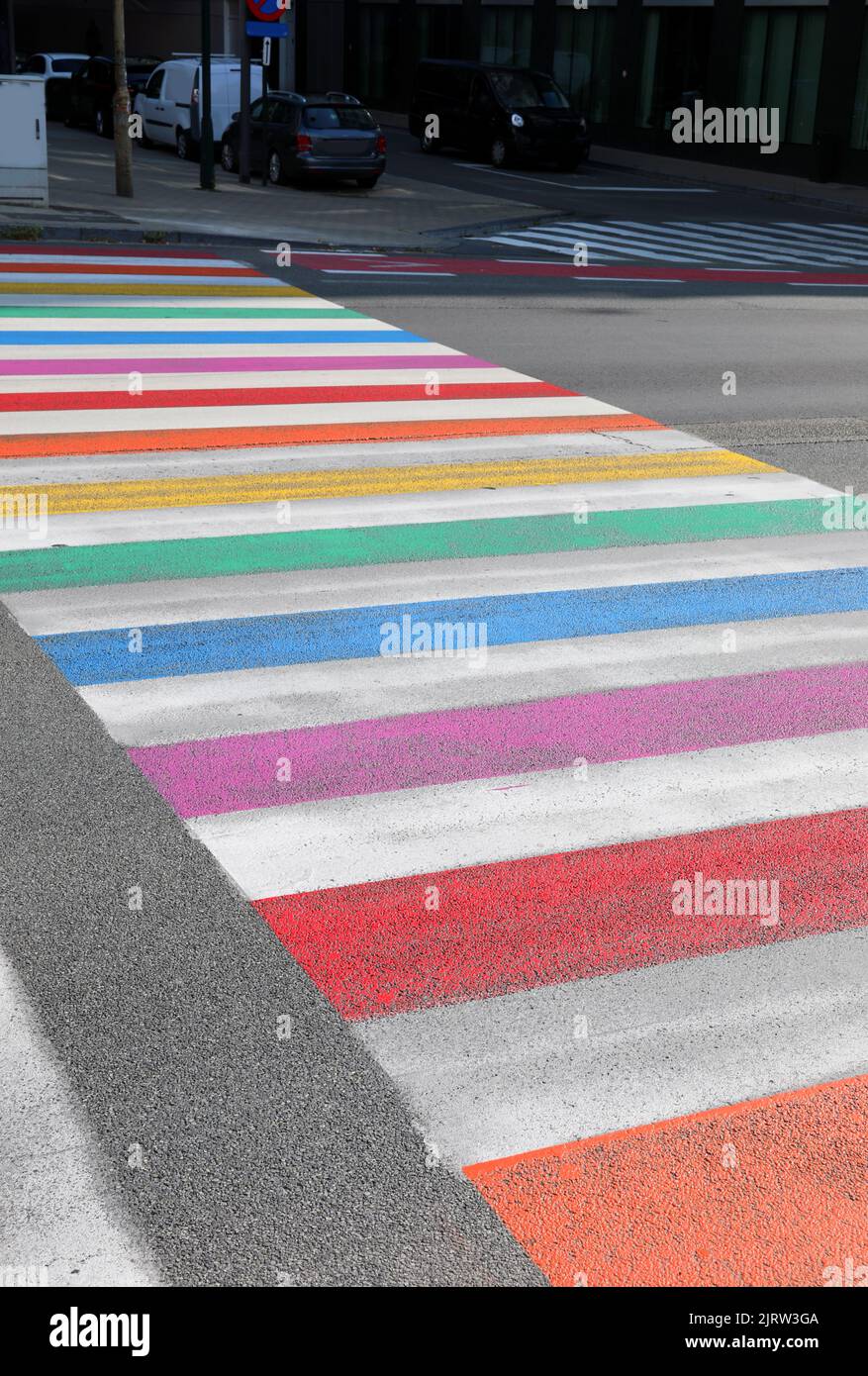 large pedestrian crossing with lines of many rainbow colors on the ...