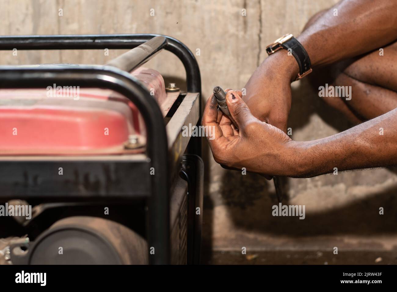african man working on a generator Stock Photo - Alamy