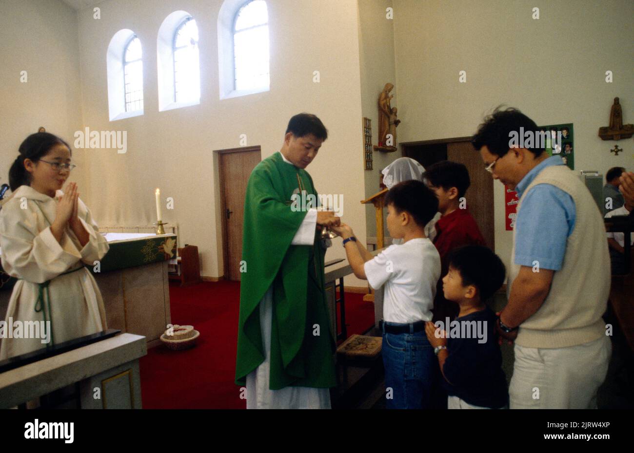 Priest Giving Communion At Korean Mass St Anne's Catholic Church ...
