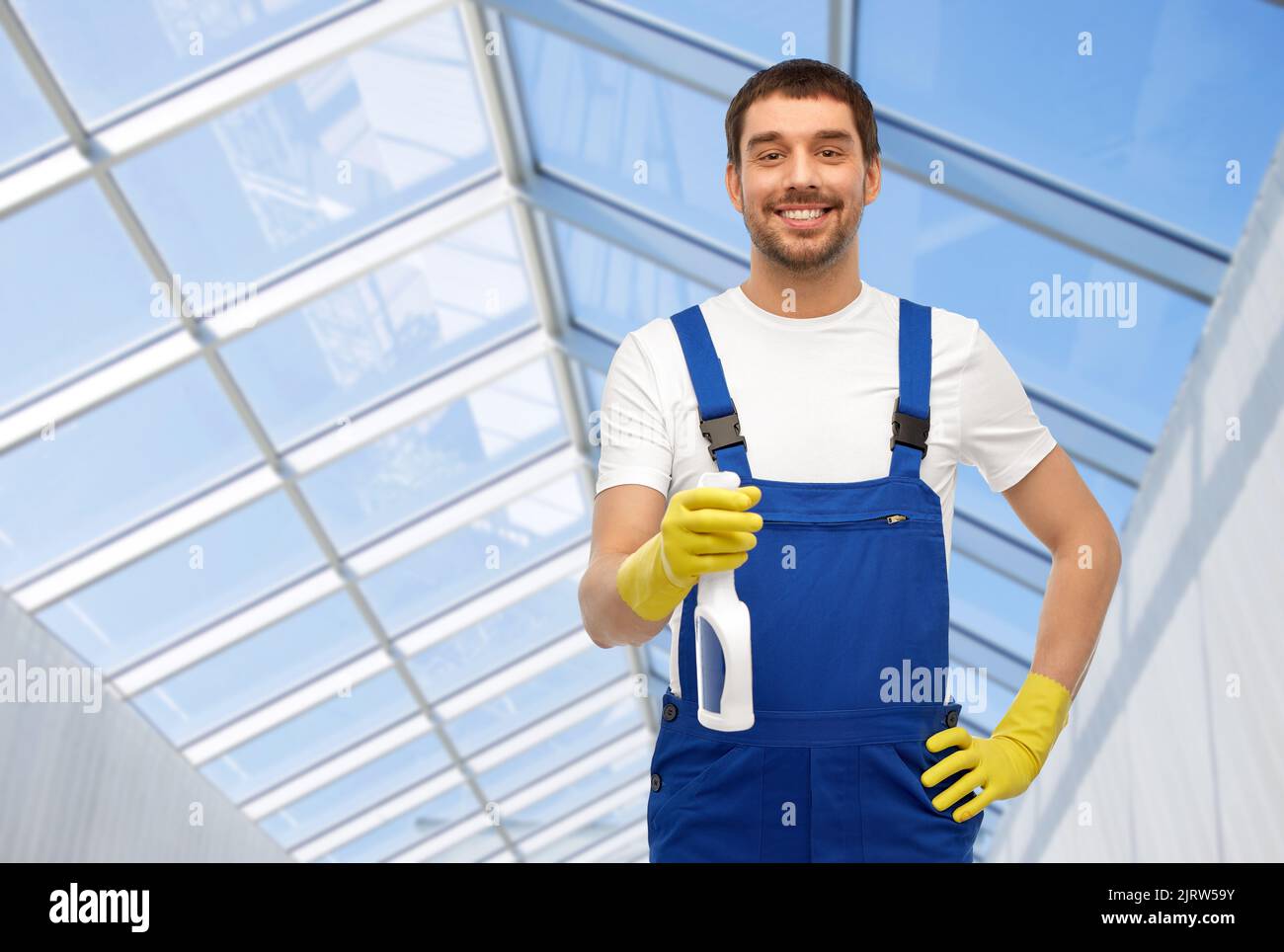 male cleaner cleaning with detergent in glasshouse Stock Photo - Alamy