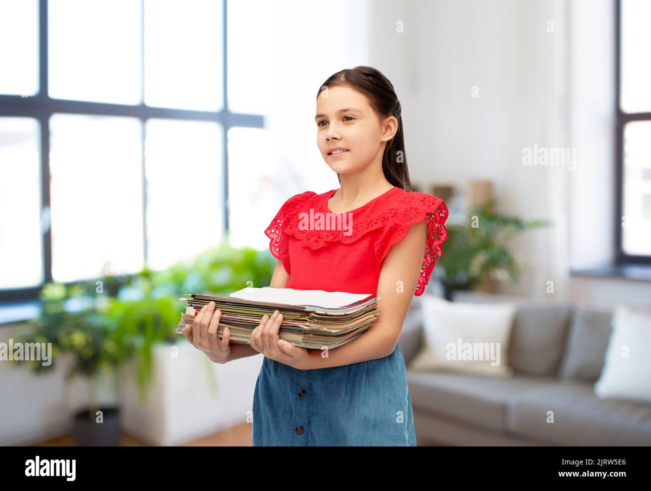 girl with magazines sorting paper waste at home Stock Photo - Alamy