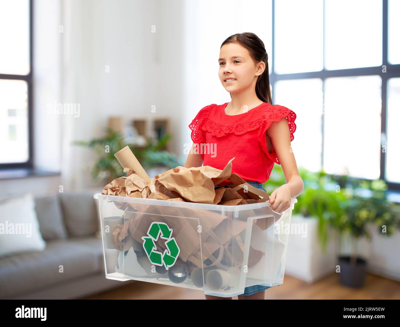 smiling girl sorting paper waste at home Stock Photo - Alamy