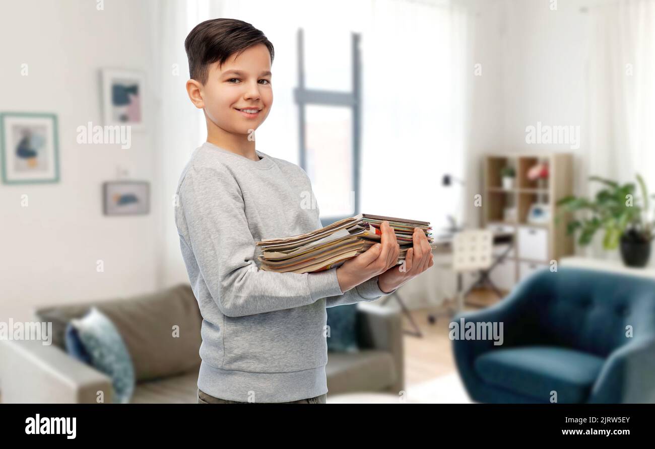 smiling boy with magazines sorting paper waste Stock Photo - Alamy