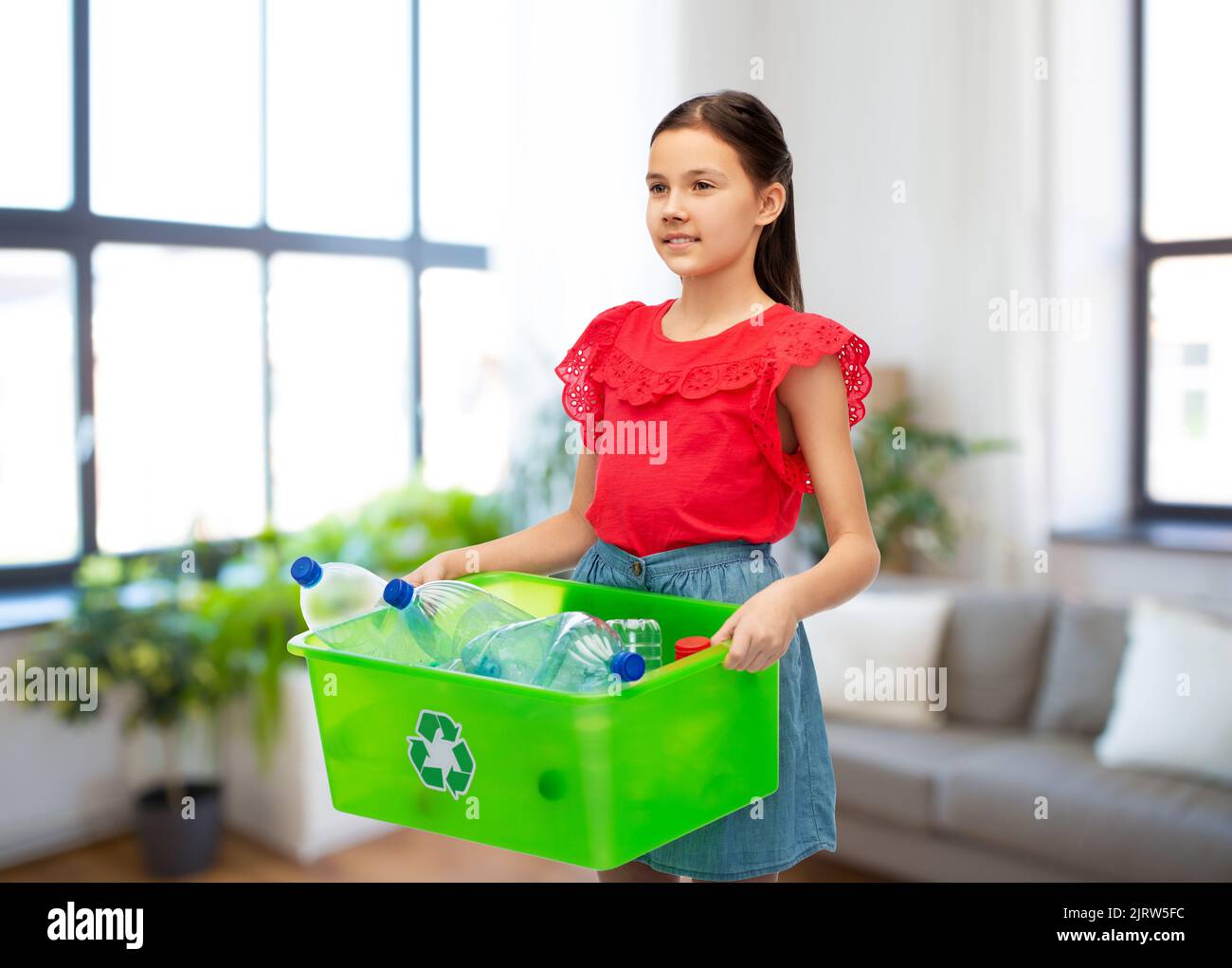 smiling girl sorting plastic waste at home Stock Photo - Alamy