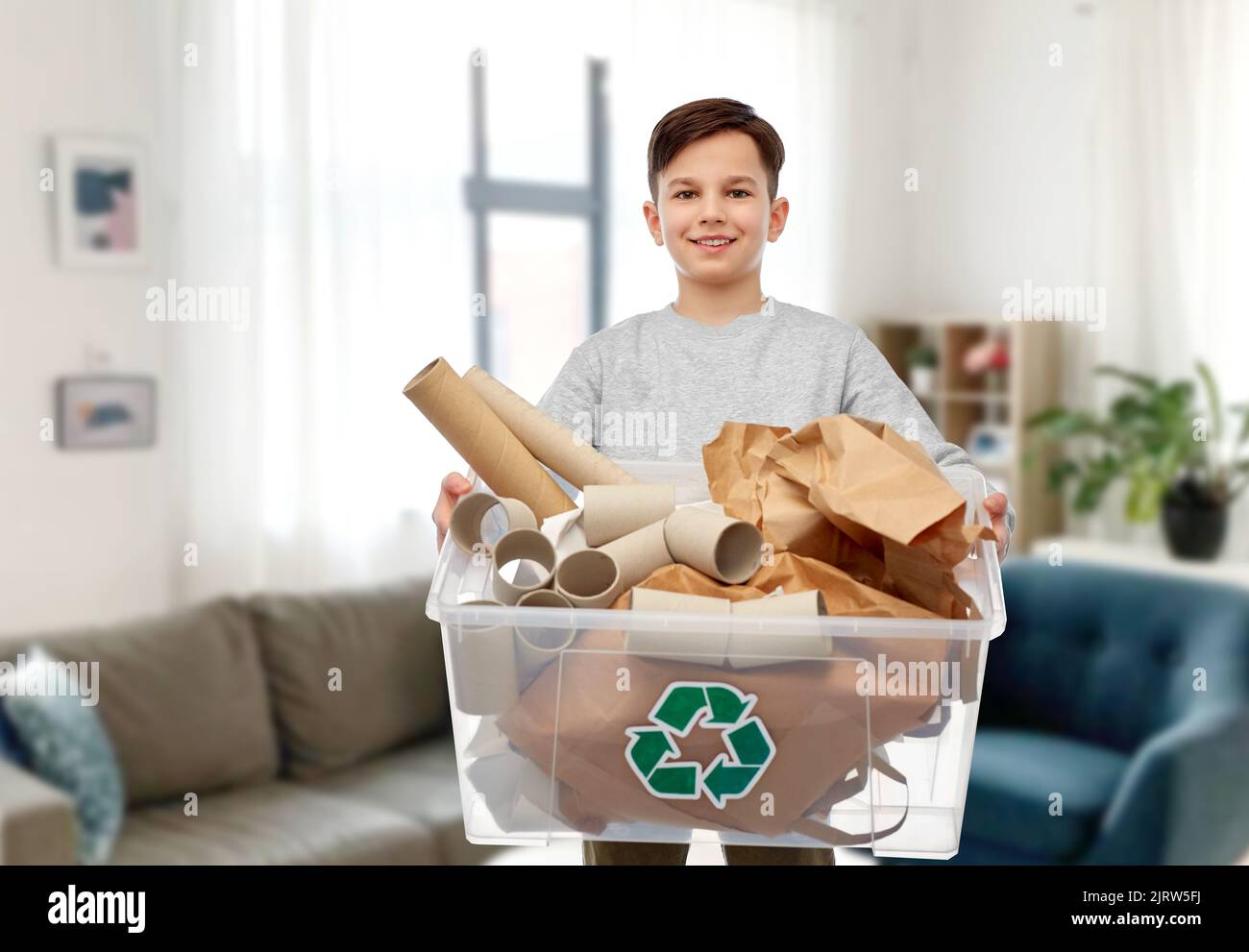 smiling boy sorting paper waste Stock Photo - Alamy