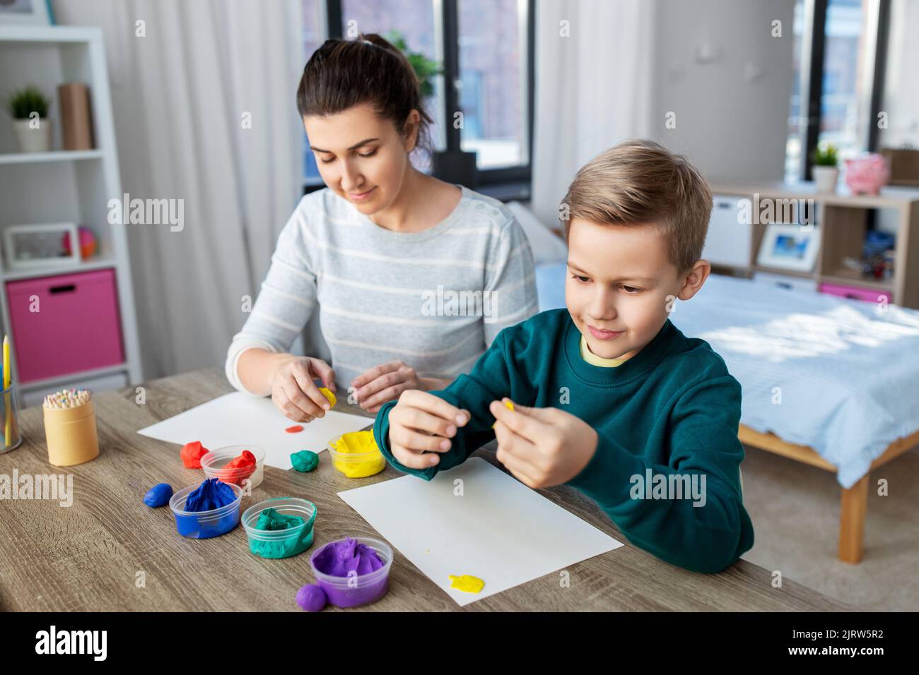 mother and son playing with modeling clay at home Stock Photo - Alamy