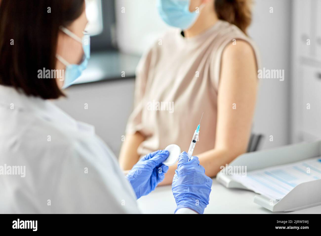 female doctor with syringe vaccinating patient Stock Photo - Alamy