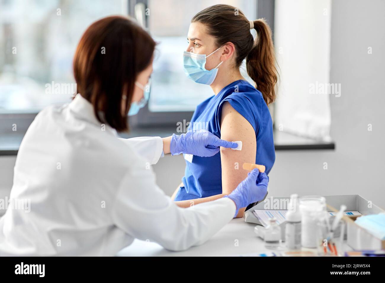 Female doctor attaching patch hi-res stock photography and images - Alamy