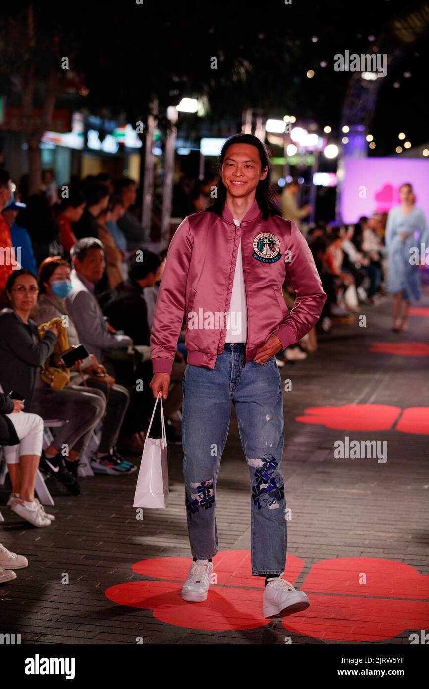 Models walk a fashion runway wearing brands from local and ...