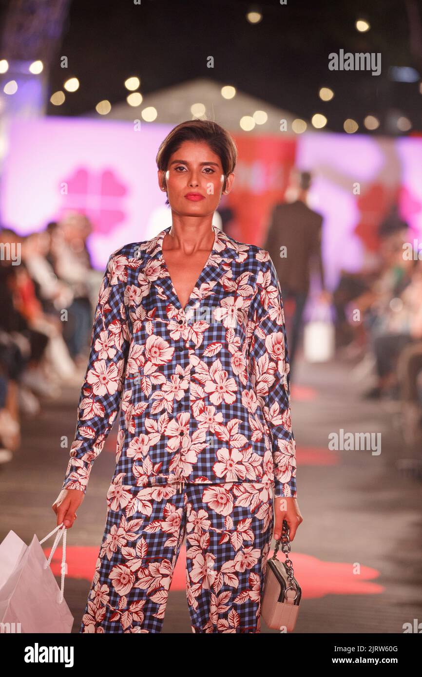Models walk a fashion runway wearing brands from local and ...