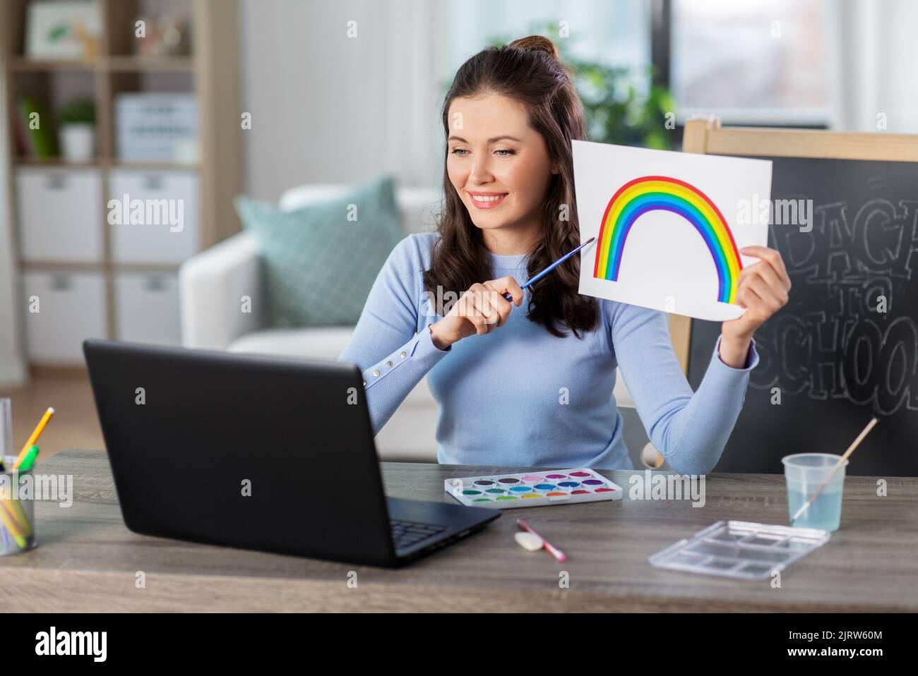 teacher with laptop having online class at home Stock Photo - Alamy