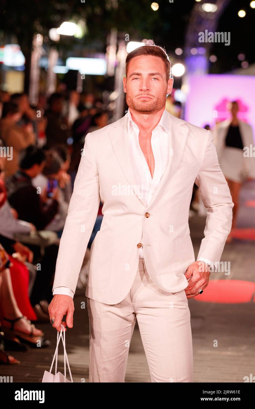 Models walk a fashion runway wearing brands from local and ...