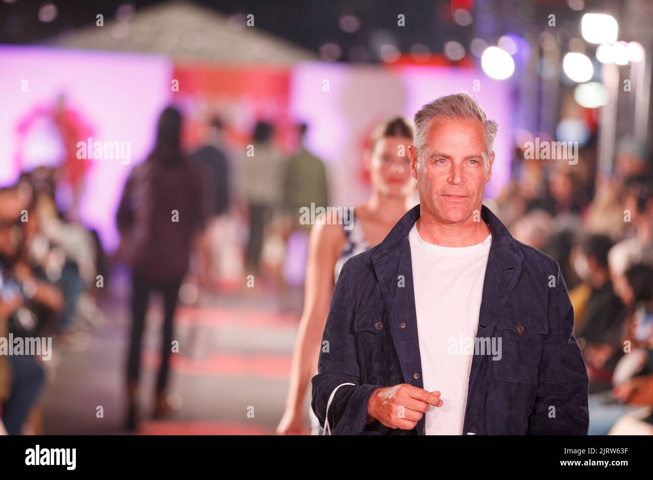 Models walk a fashion runway wearing brands from local and ...