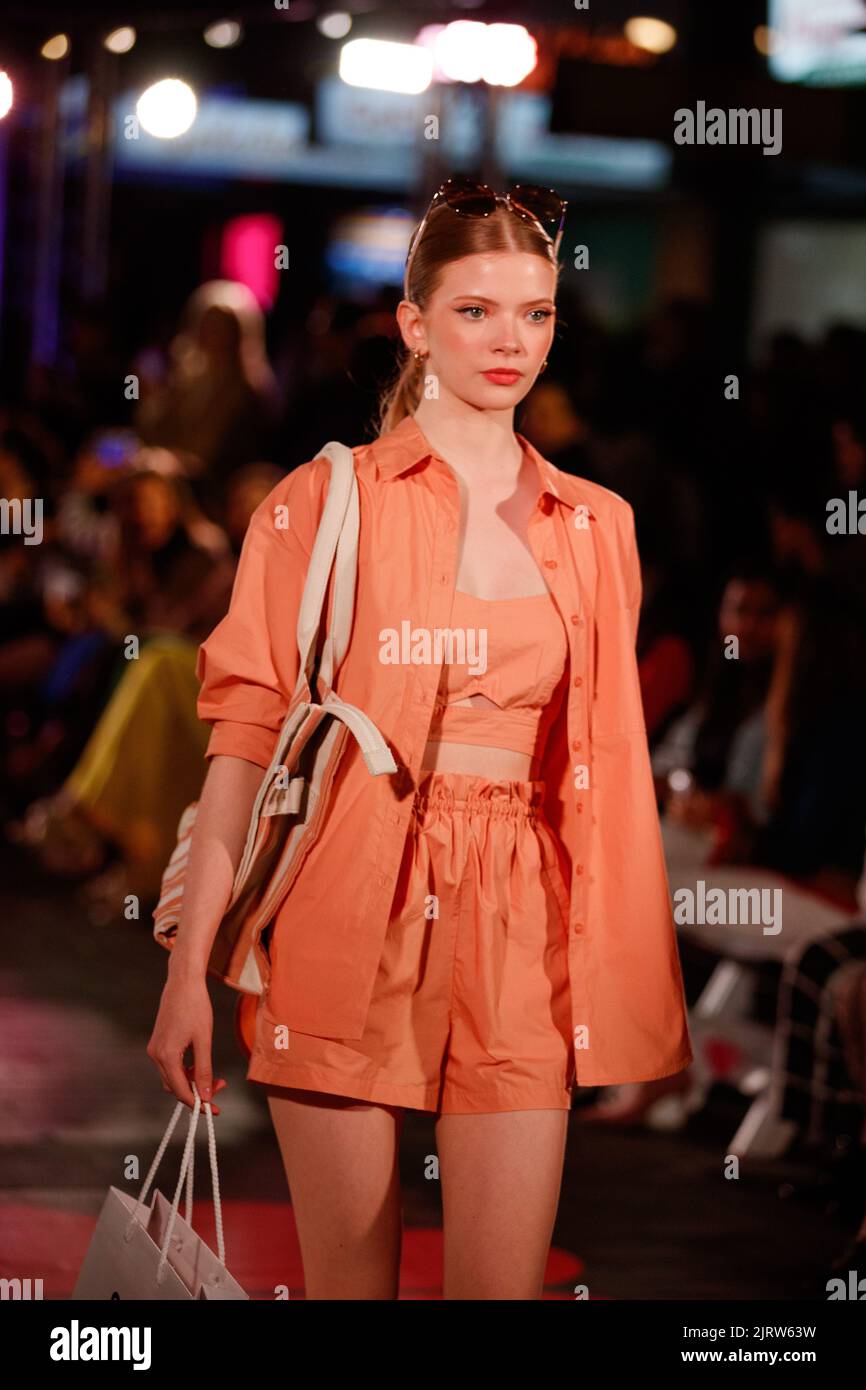 Models walk a fashion runway wearing brands from local and ...