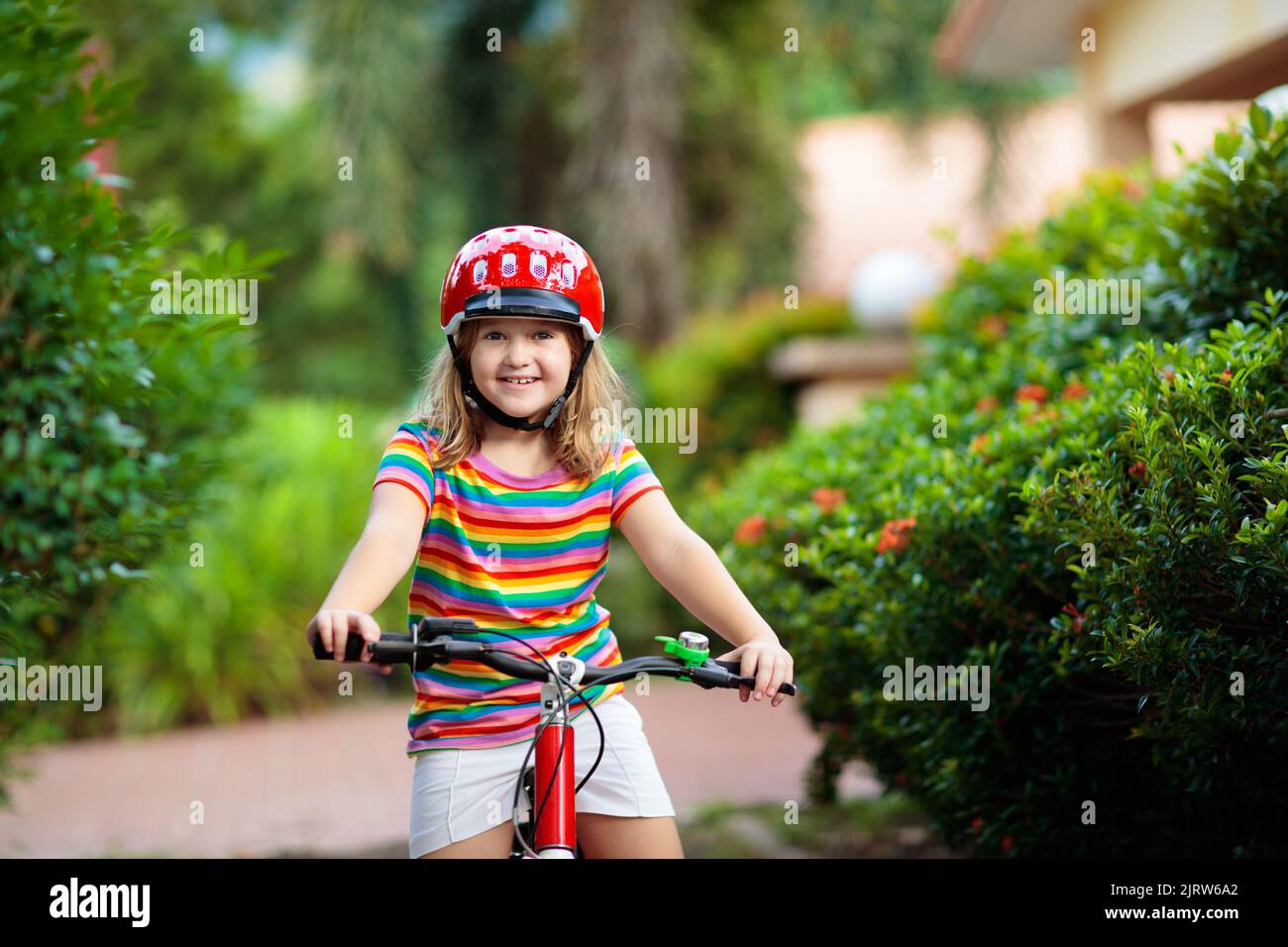 Kids on bike in park. Children going to school wearing safe bicycle ...