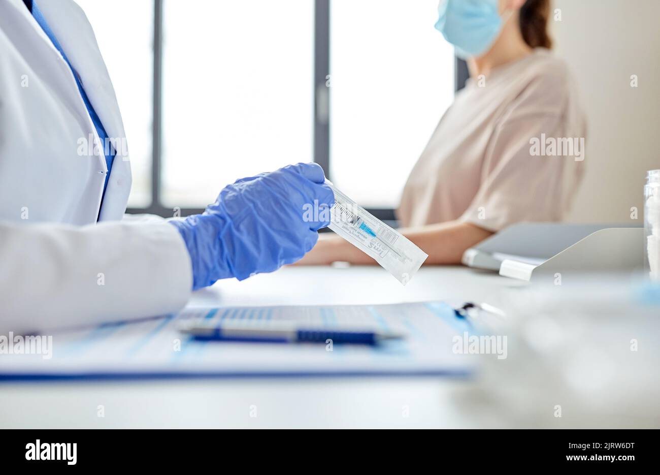 female doctor with syringe and patient at hospital Stock Photo - Alamy