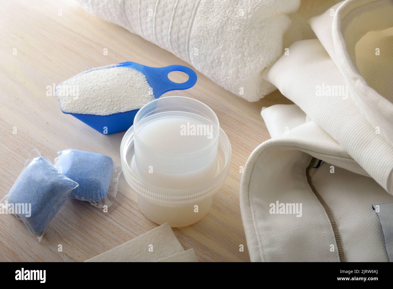 Detail of different types of laundry detergents on wooden table with ...