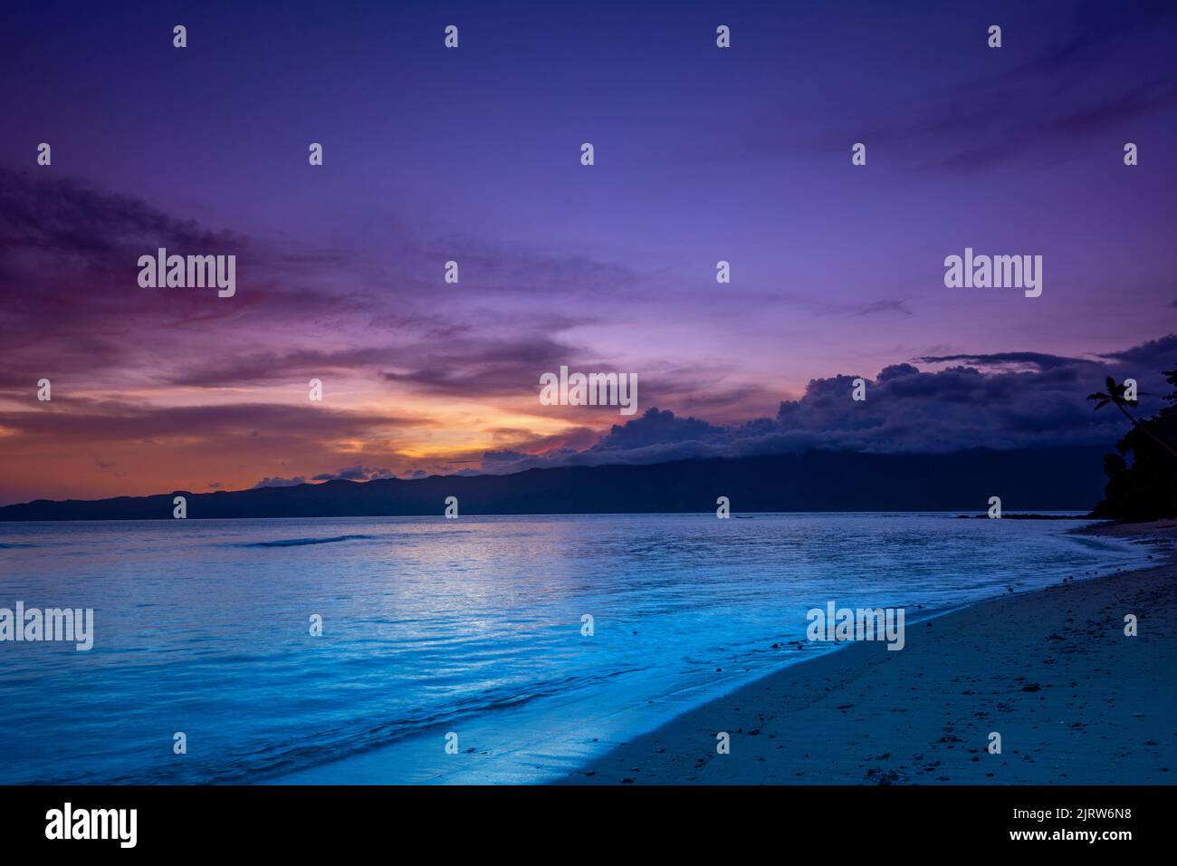 Early morning blue light during sunrise casts an aqua tone to the water ...