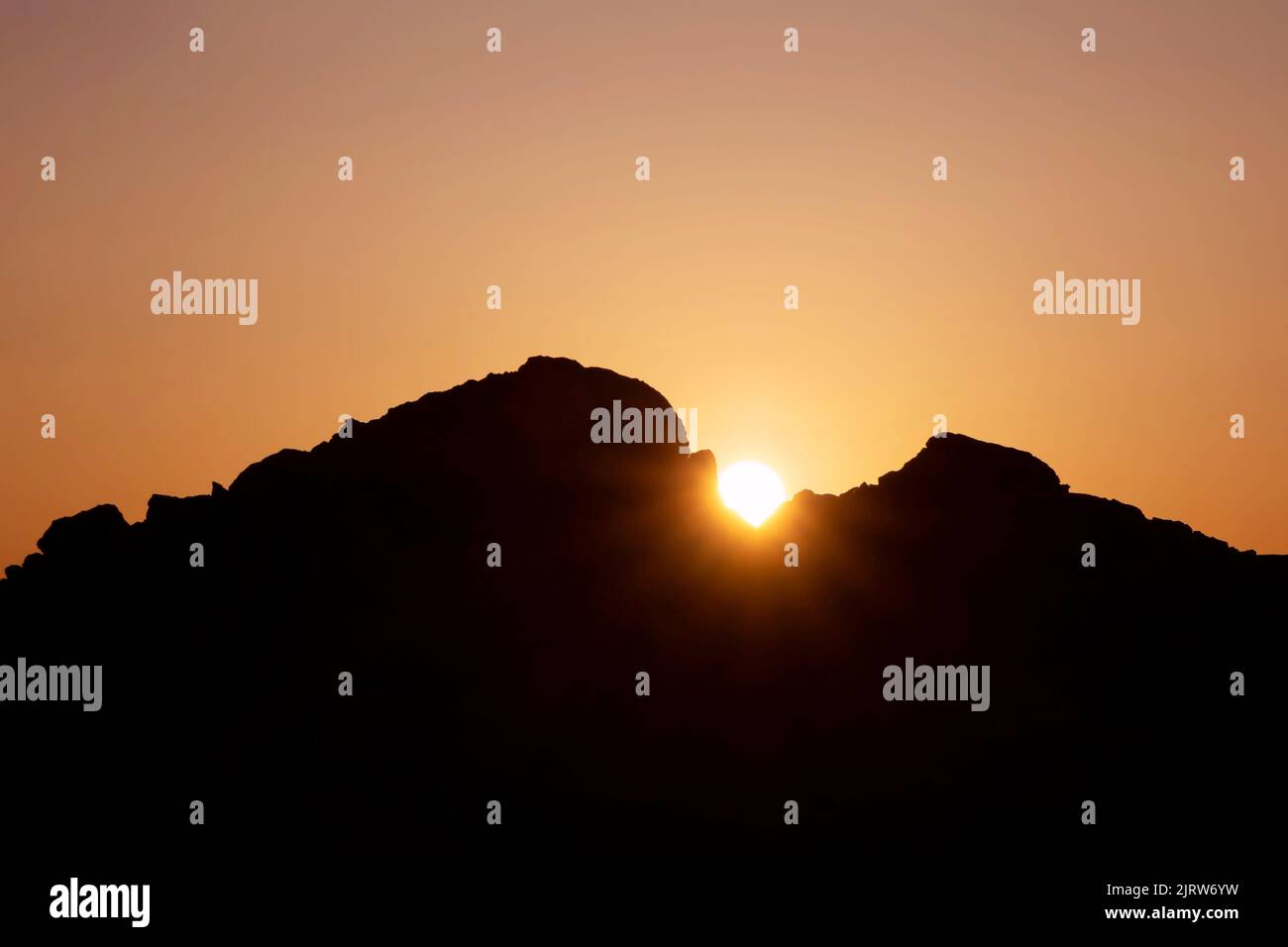 landscape with sun rising behind rocks at morning Stock Photo - Alamy